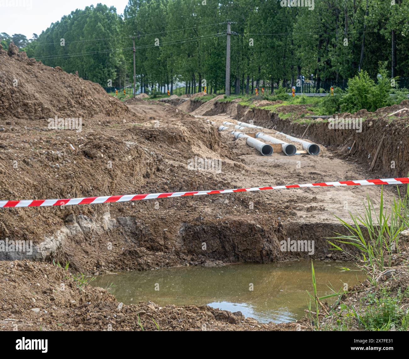 New fiber glass water pipeline in trench. Replacement of old rusty ...
