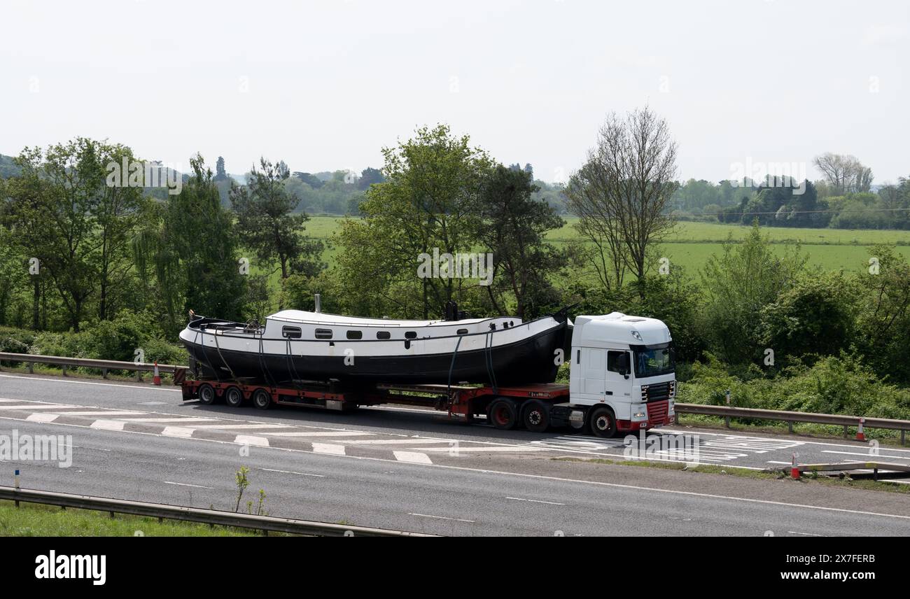 A low loader lorry carrying a large boat, M40 motorway, Warwickshire ...