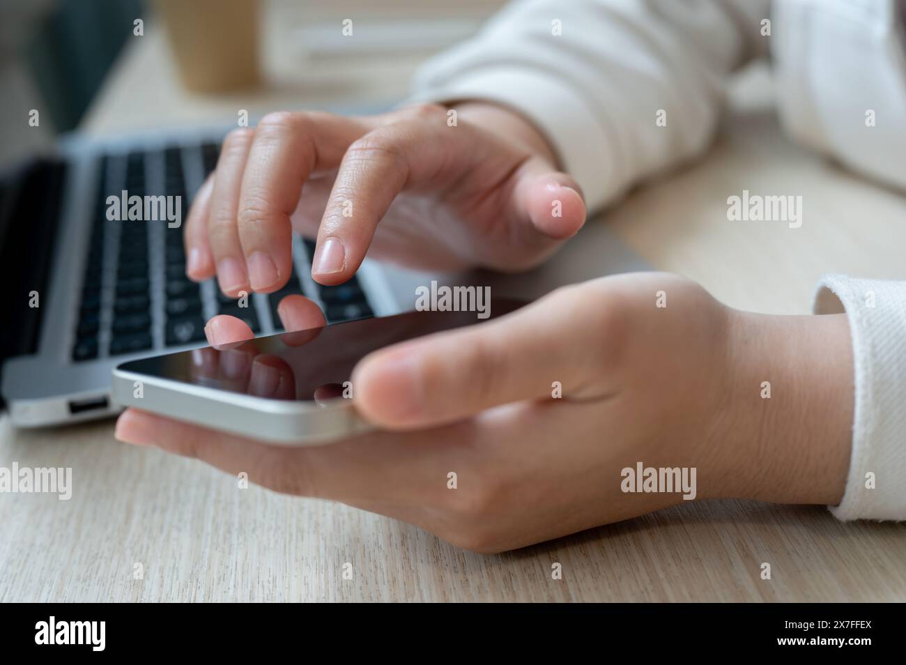 A close-up image of a woman touching on her smartphone screen, checking ...