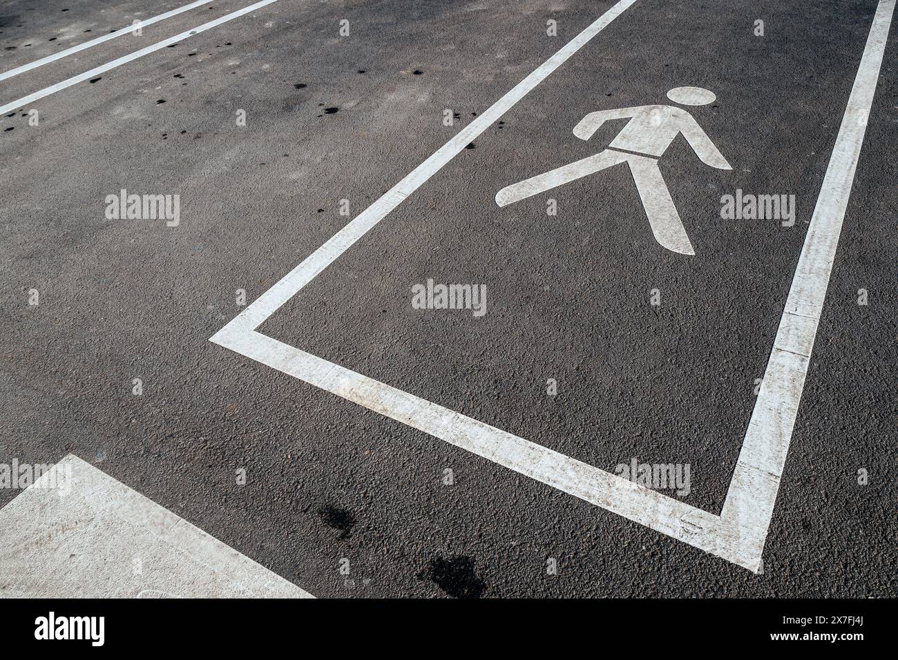 Pedestrian path sign on asphalt ground, symbol of a man walking, high ...