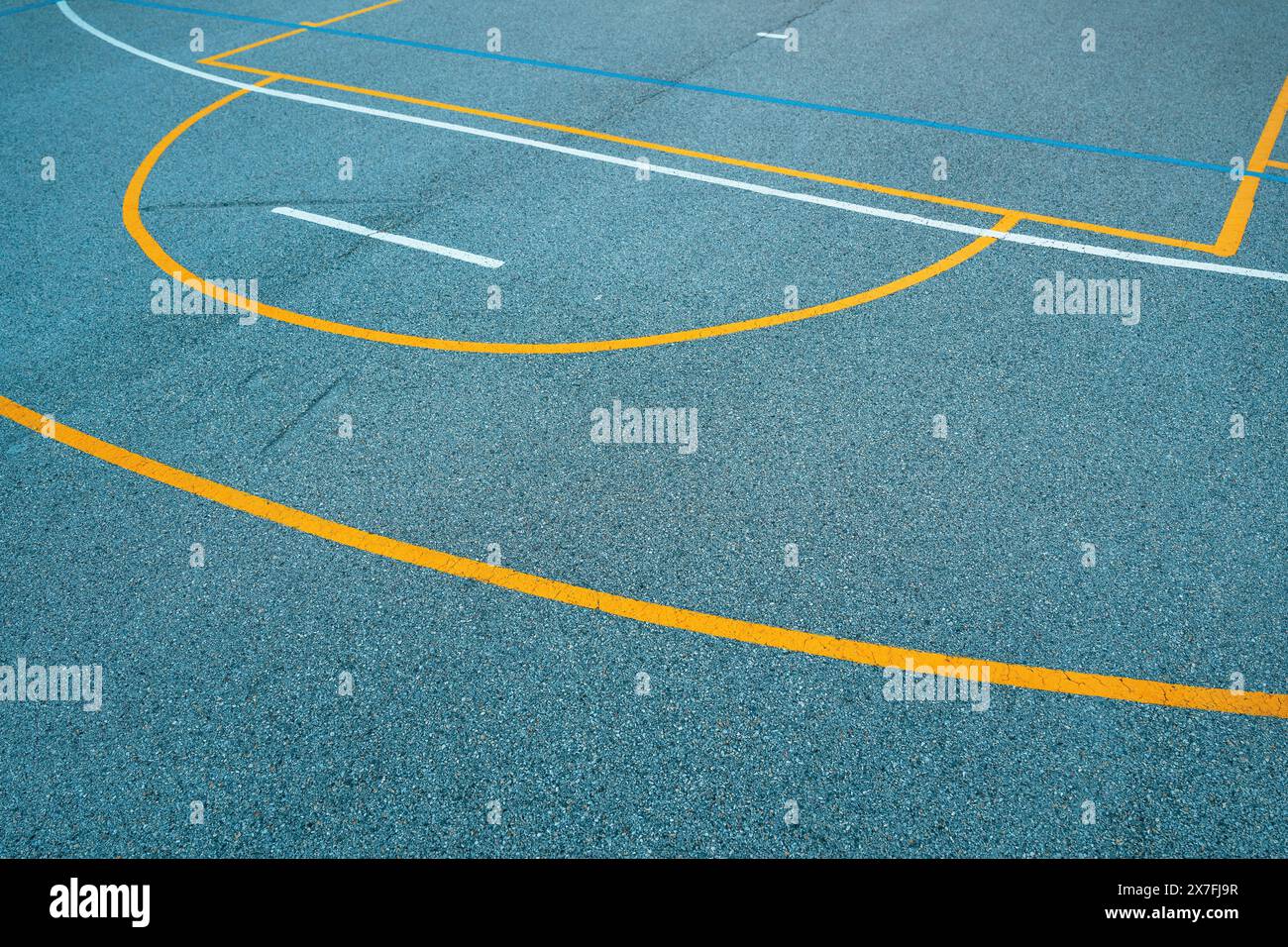 Outdoor basketball court lines and markings on concrete flooring ...
