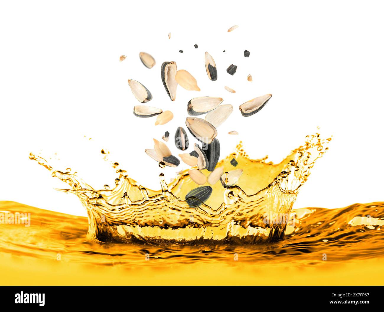 Sunflower seeds falling into cooking oil on white background Stock ...