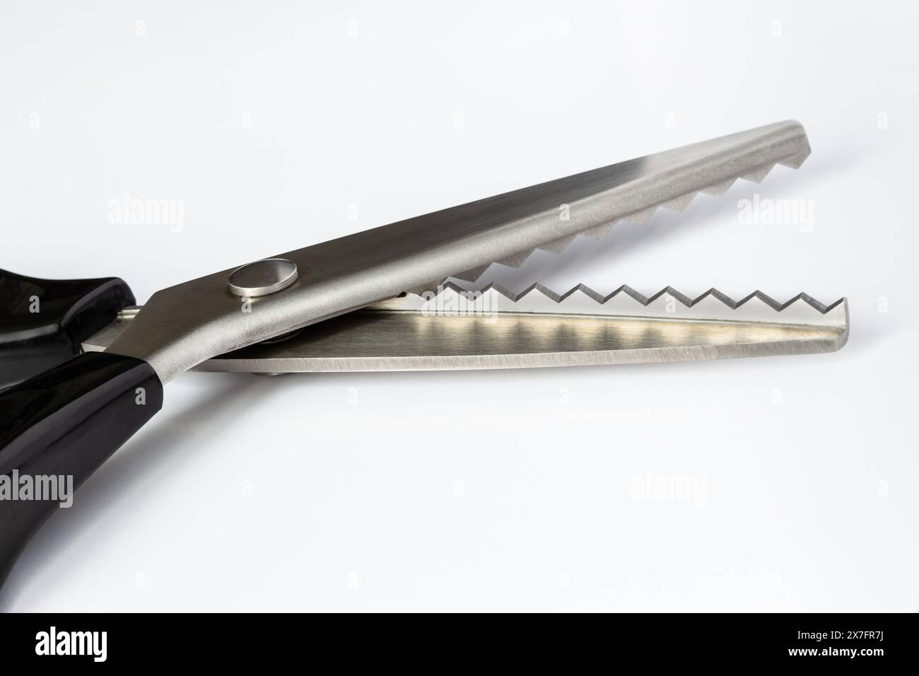 Special tailor's scissors with serrated zigzac edge on white background ...