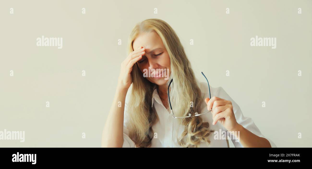 Exhausted tired caucasian mature woman employee with headache, stress ...