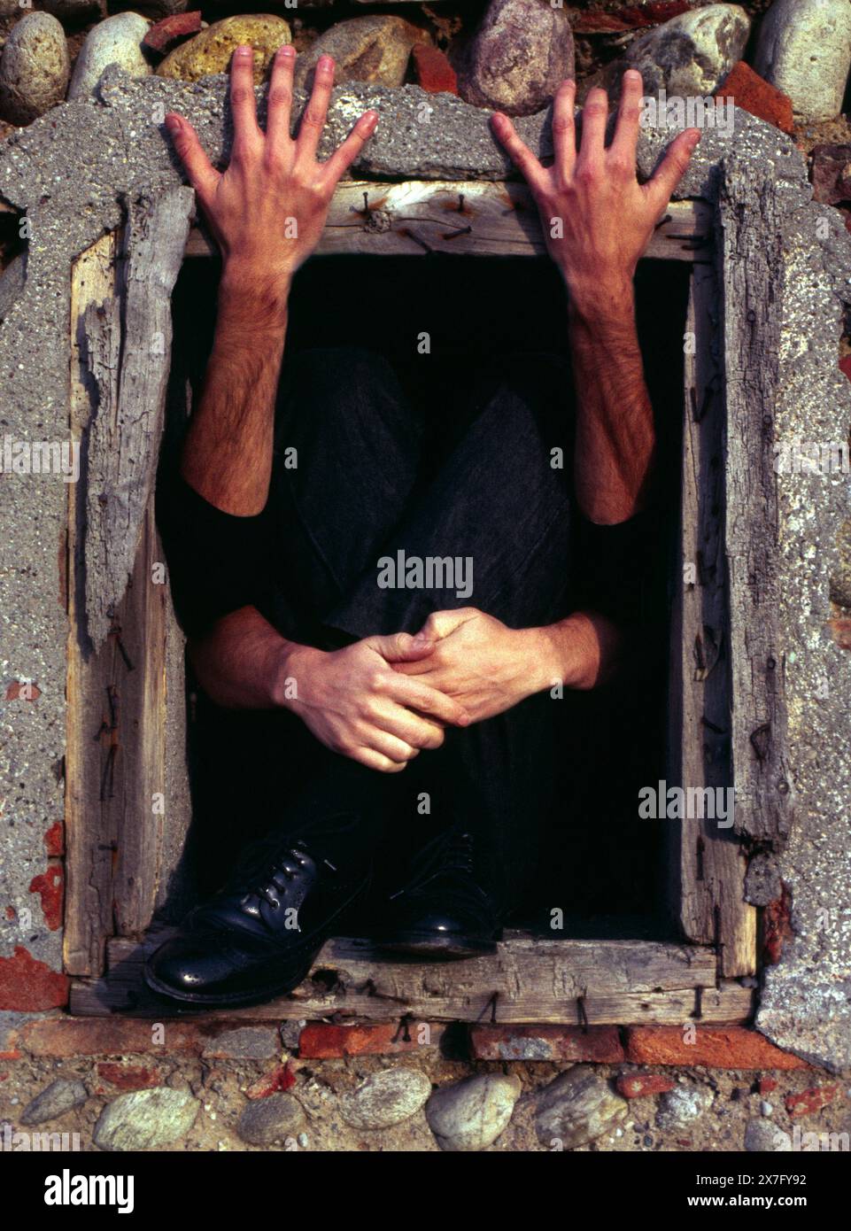 Man Getting out of a Window Stock Photo - Alamy