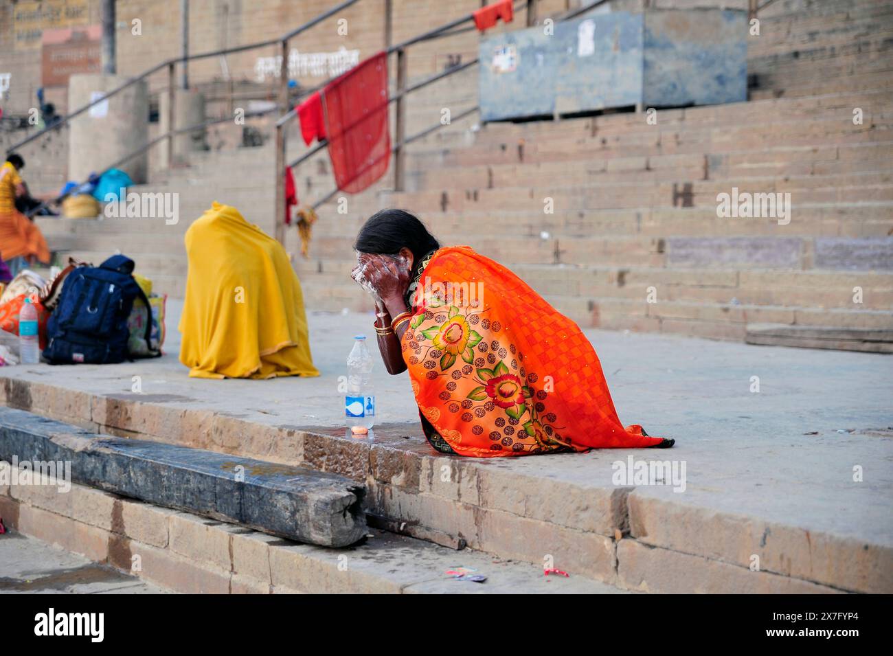 Indian pilgrim performing Puja on the banks of the Ganges River ...