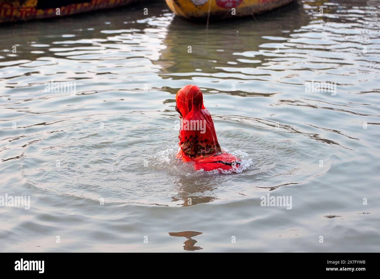 Indian pilgrim performing Puja on the banks of the Ganges River ...