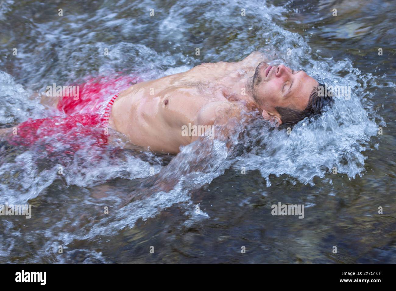 Man relaxing in mountain river. Healthy lifestyle. Calm man swimming in ...