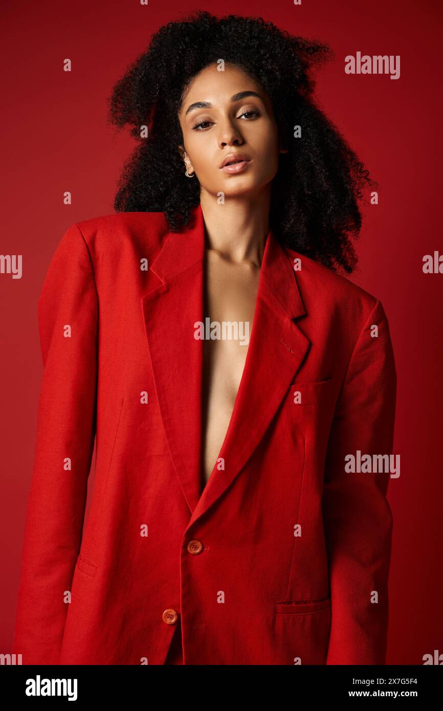 A young woman exudes confidence and poise as she poses in a stylish red ...