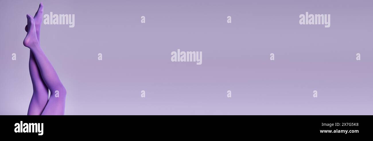 female legs clad in striking purple stockings and a matching backdrop ...