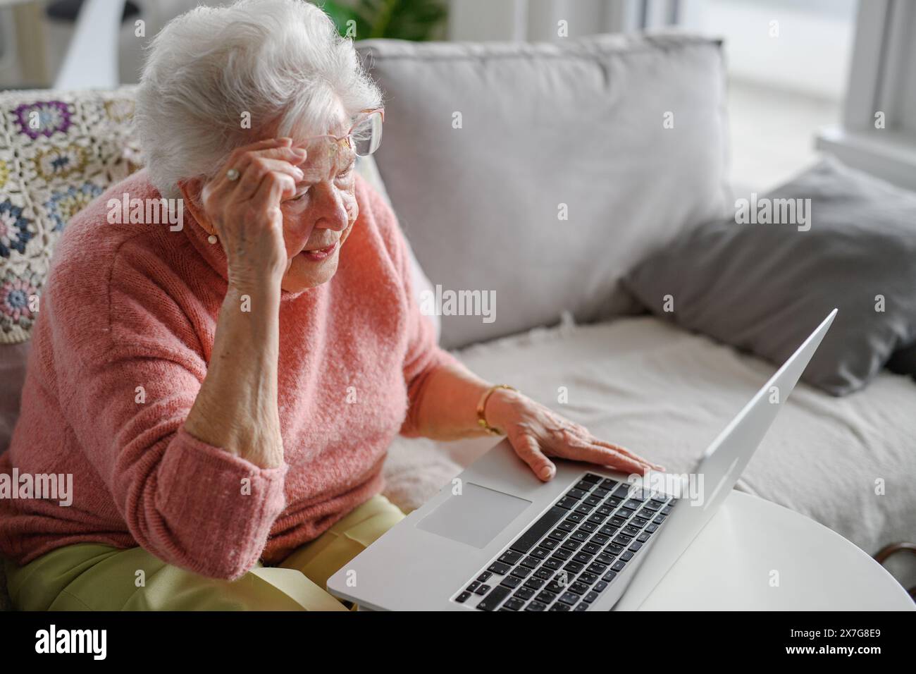 Senior woman learning to work with laptop, technology and internet ...