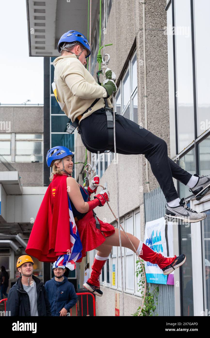 Anna Firth MP abseiling down the 154 ft (47 metres) of the main tower ...