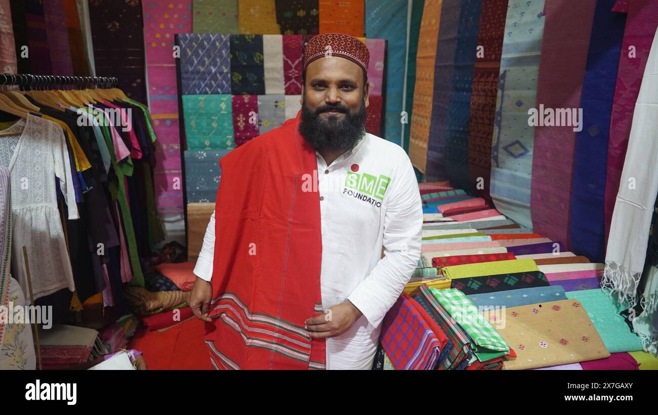 Dhaka. 20th May, 2024. A man shows products at a stall during ...