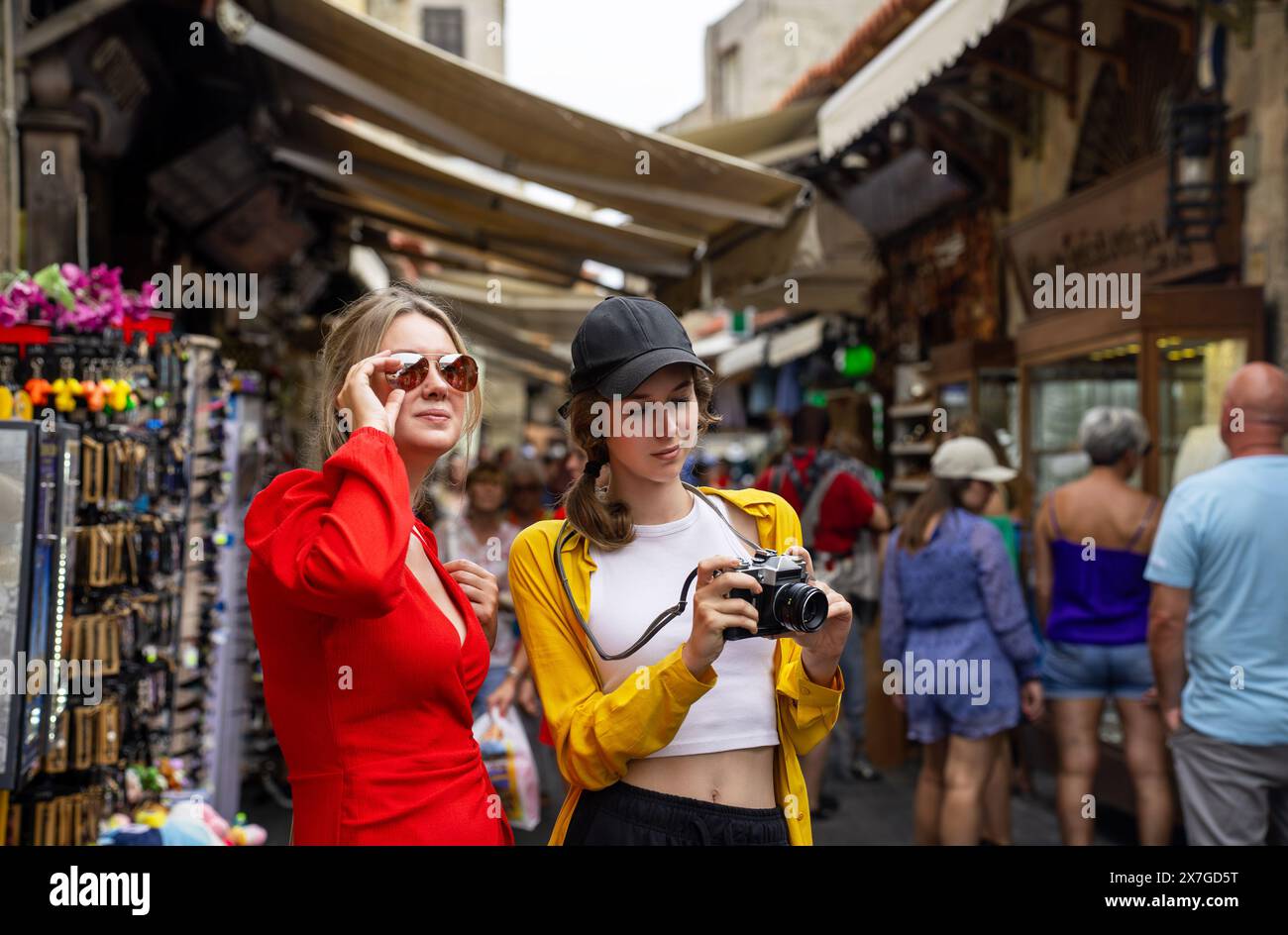 Two tourists take photos in a crowded tourist city Stock Photo - Alamy