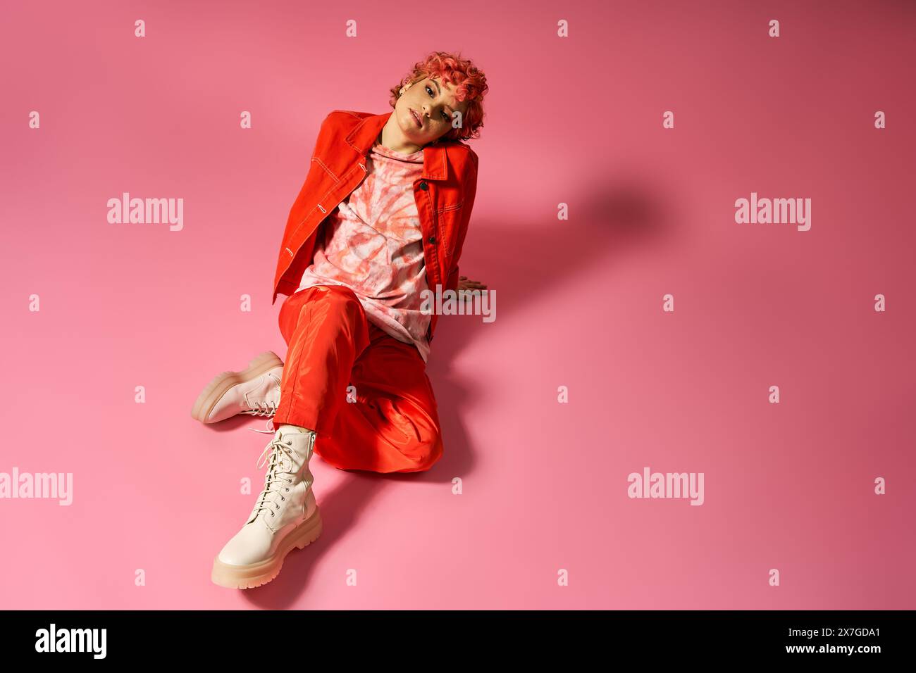 A woman in a red jacket laying on the ground Stock Photo - Alamy