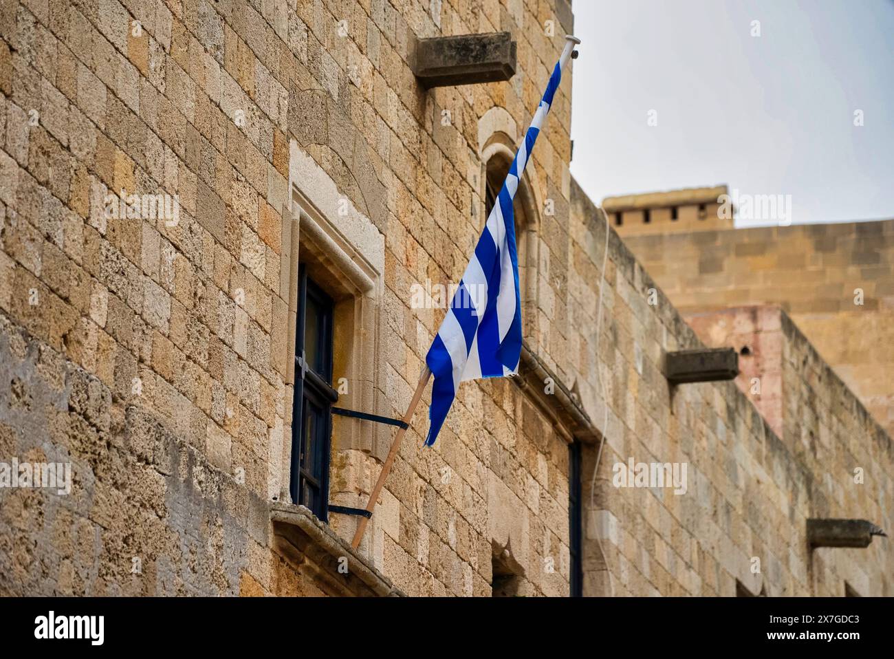 The Greek flag hangs on the wall of the building Stock Photo - Alamy