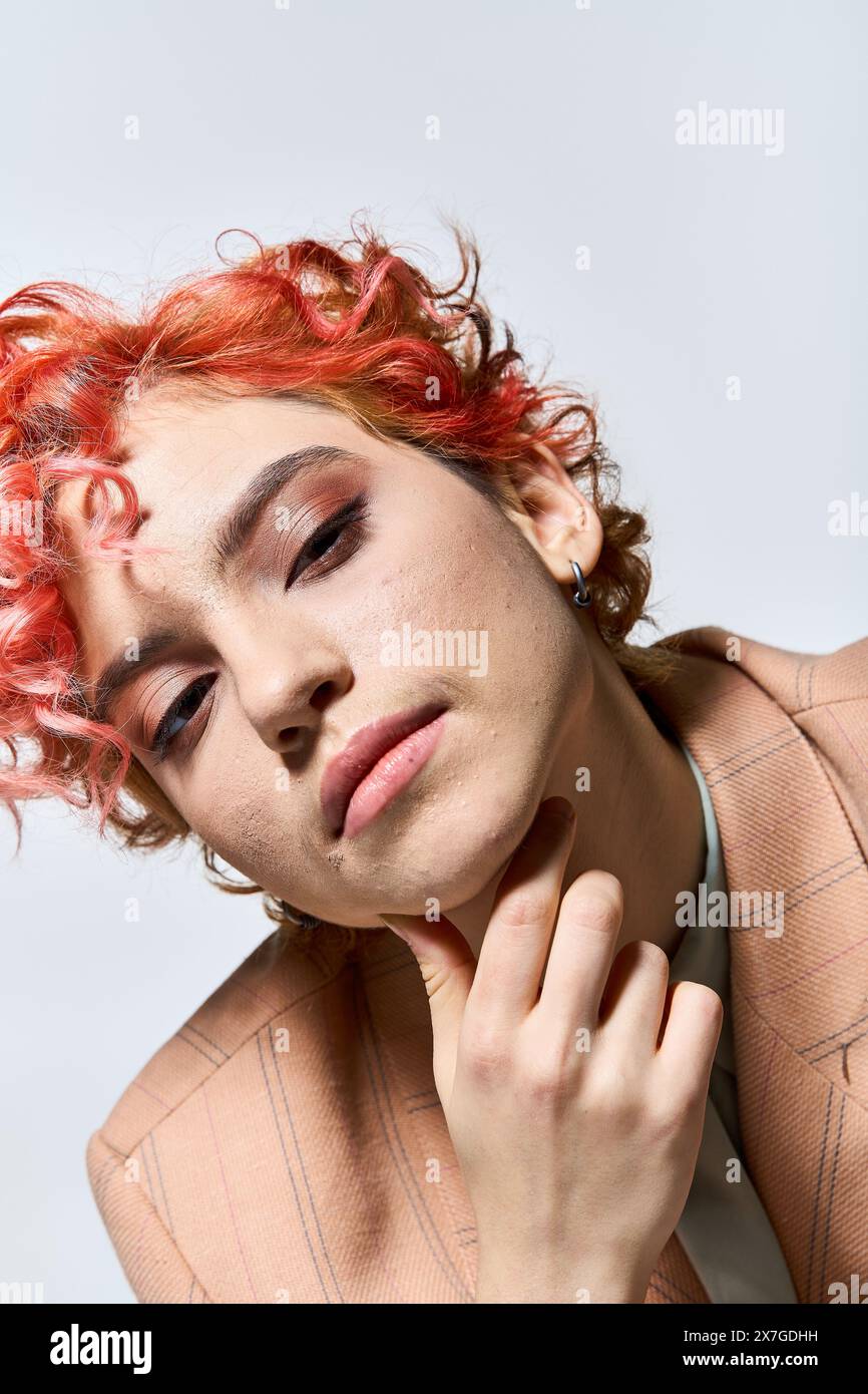 A vibrant woman with red hair strikes a confident pose Stock Photo - Alamy