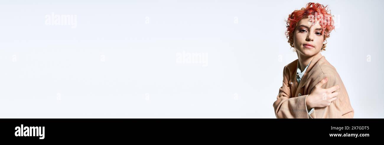 A woman with red hair strikes a pose for a photo Stock Photo - Alamy