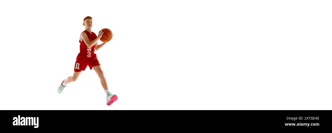 Boy in red uniform, basketball player running with ball isolated on ...