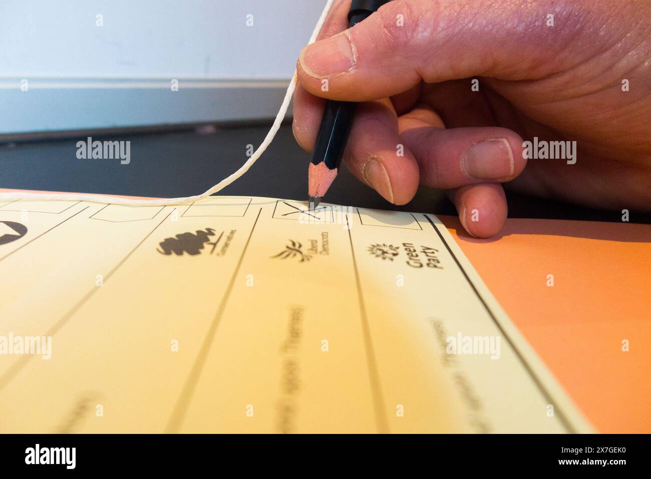 Ballot paper and pencil as voter makes choice to cast a vote and make a ...