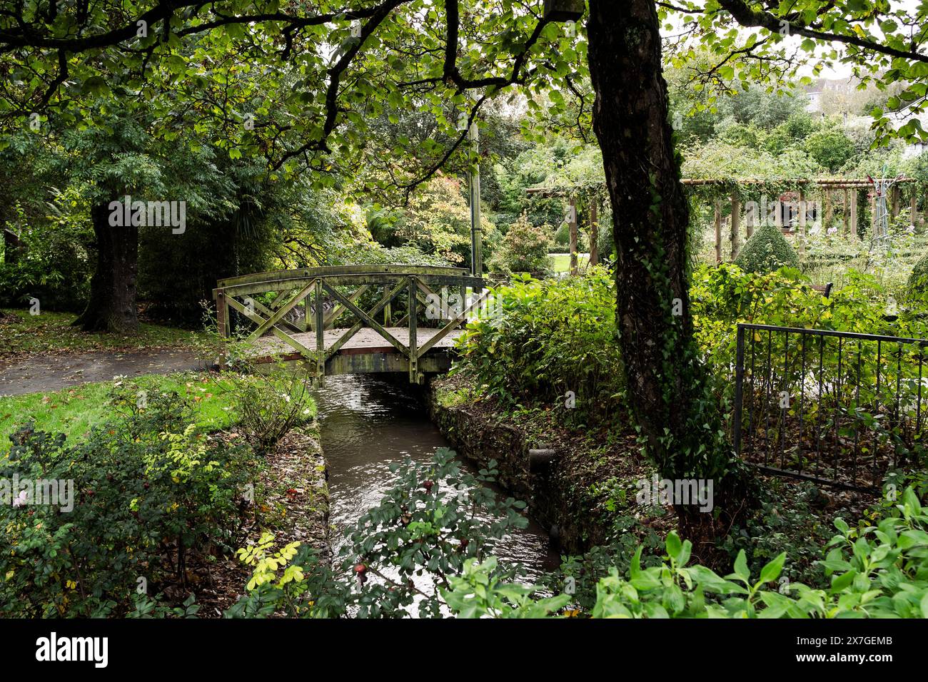 A wooden footbridge over a small stream in Trenance Gardens in Newquay ...