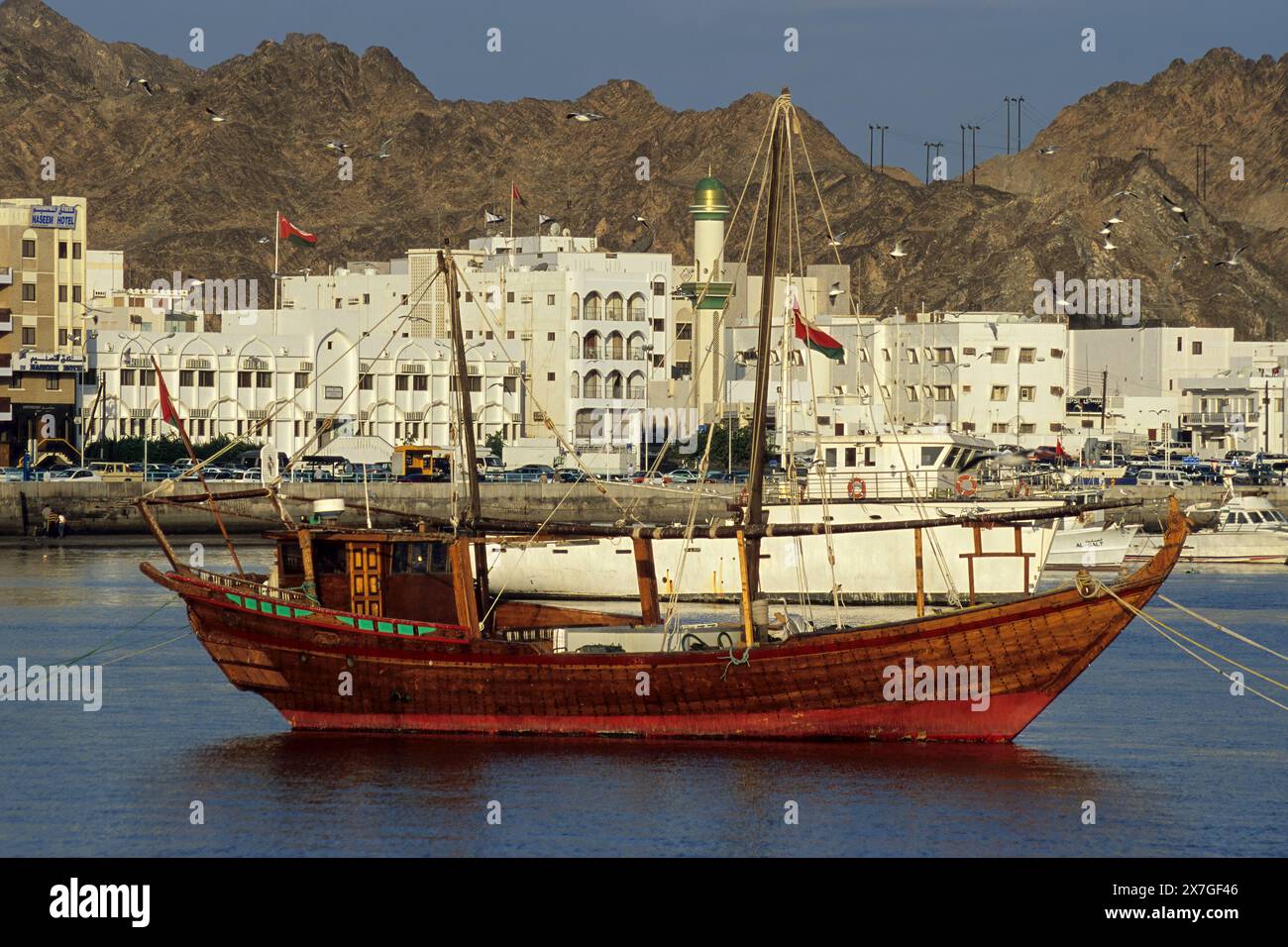 Mutrah, Oman. An Arab dhow and traditional waterfront architecture ...