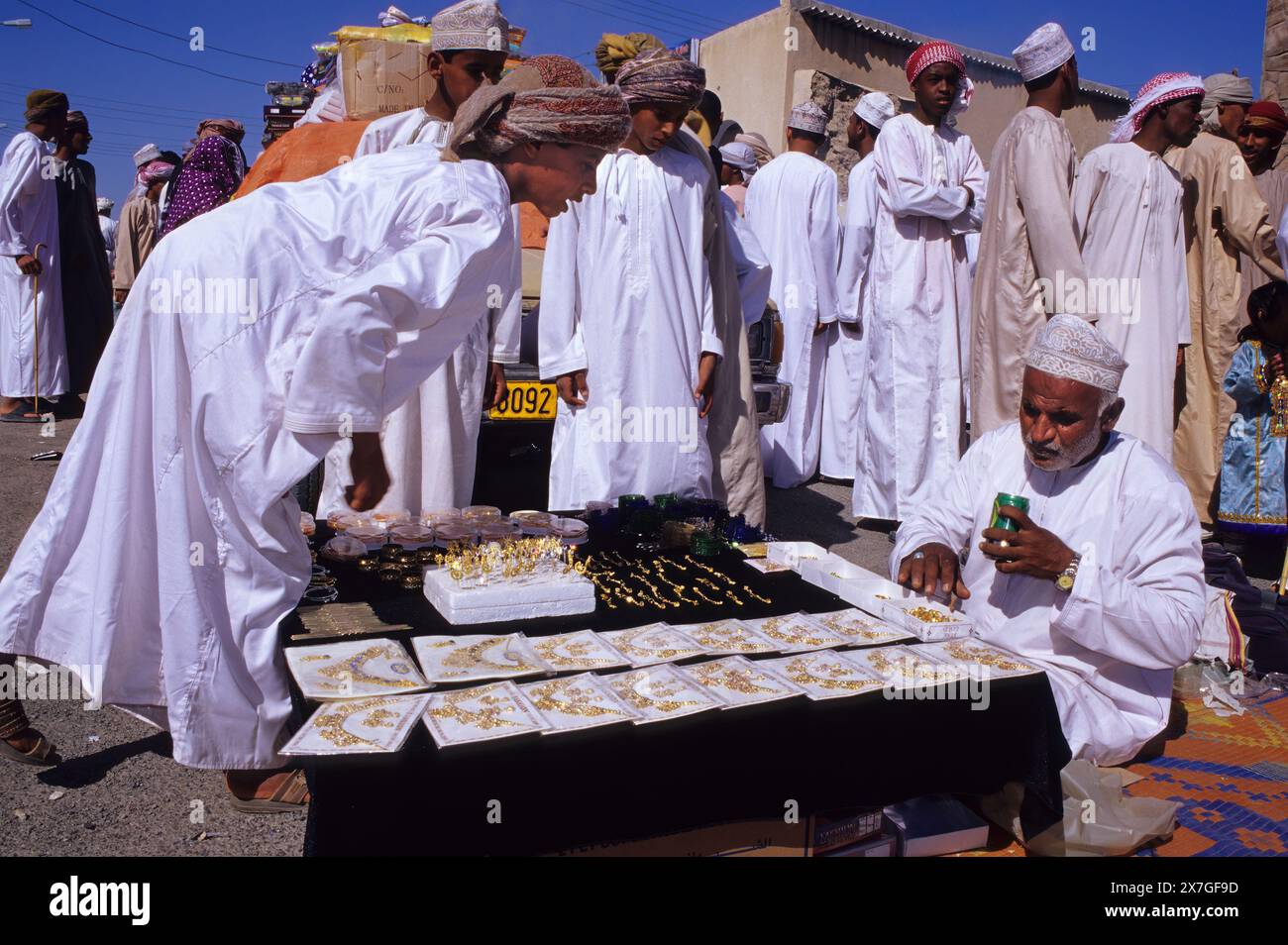 Mudayrib, Oman, Middle East - Omani boy shopping for a golden trinket ...