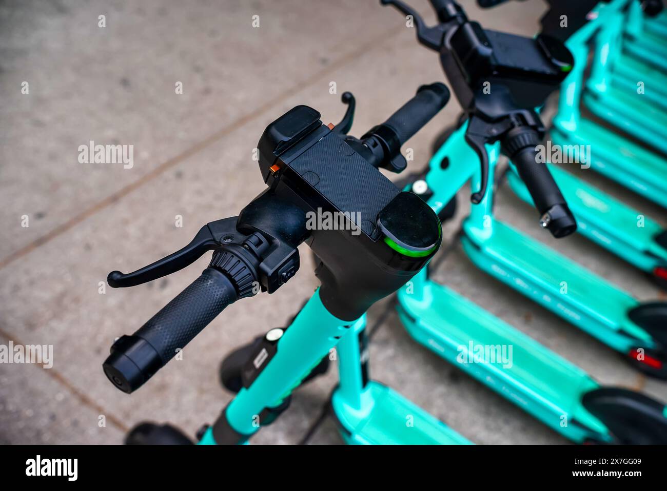 Lot of electric scooters in the rental area Stock Photo - Alamy