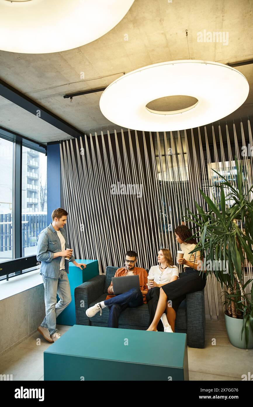 A diverse group of colleagues in a modern coworking space, sitting and ...