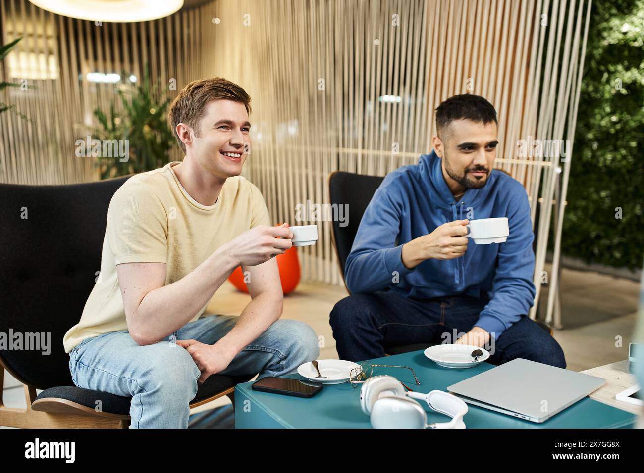 Two colleagues in a coworking space, sharing ideas and collaborating on ...
