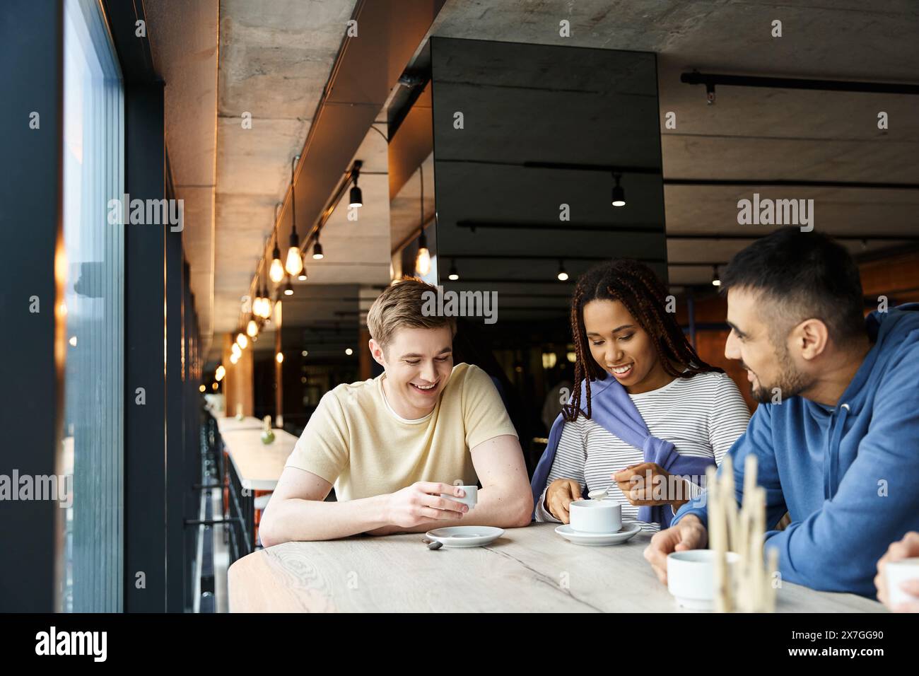A diverse group of colleagues from a startup team enjoying a coffee ...