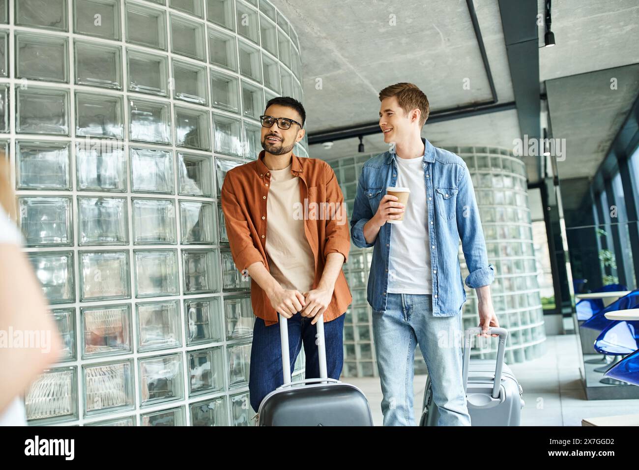 Two colleagues standing with luggage, ready for a corporate trip ...