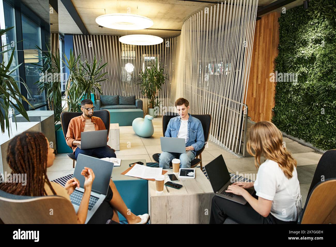 Tech team collaborating around table hi-res stock photography and ...