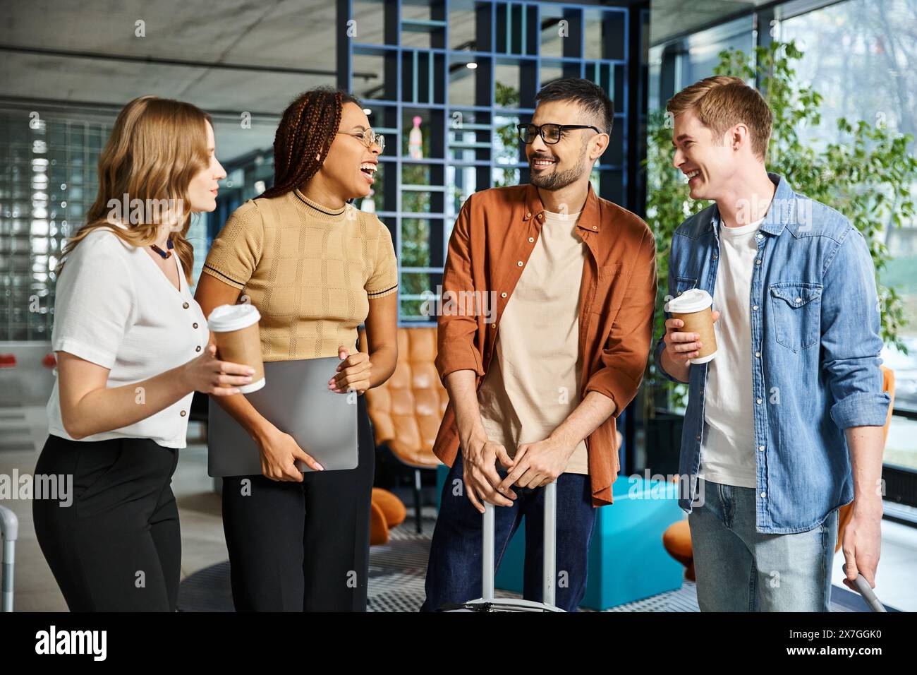 Multicultural colleagues in casual attire stand together in a hotel ...