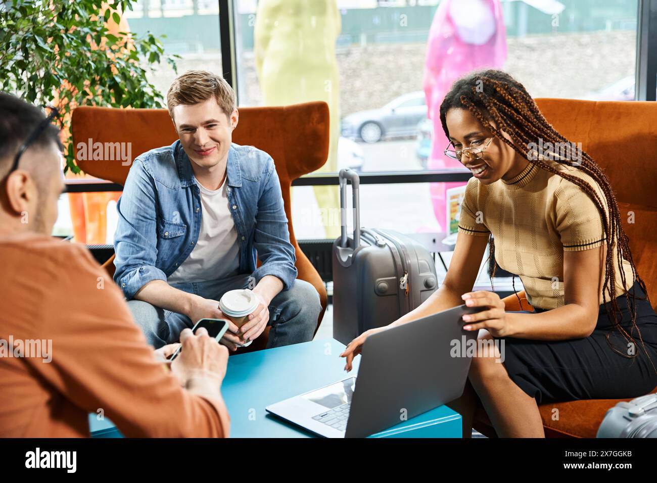 Diverse group of businesspeople in casual attire, sitting around a ...