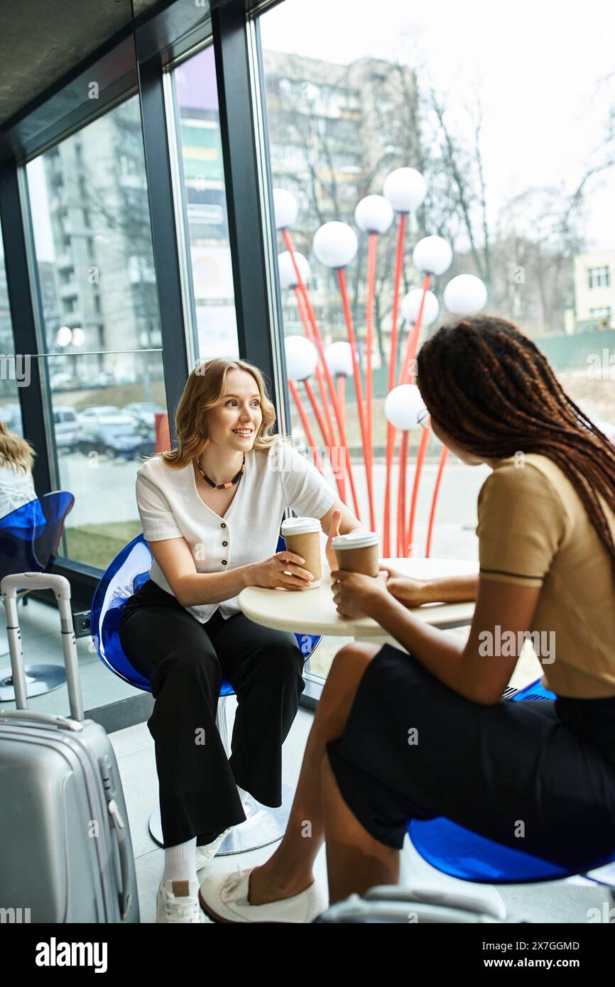 Multicultural colleagues engage in lively discussion around a table ...