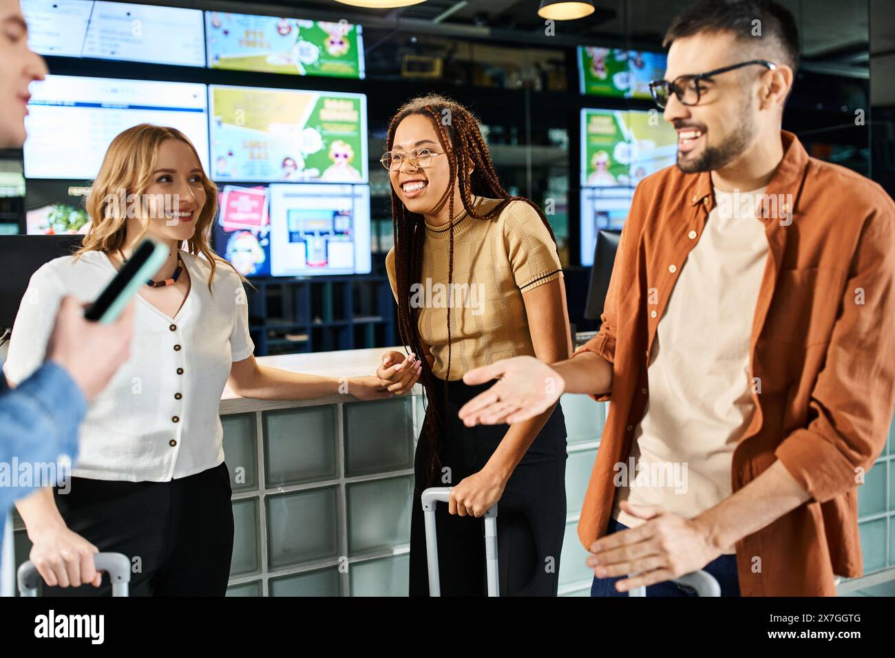 Multicultural colleagues in casual attire stand together in a hotel ...