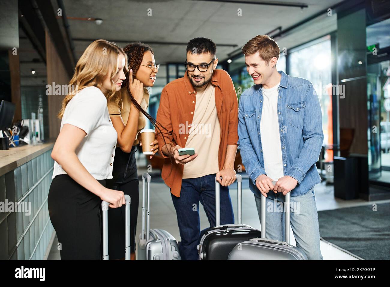 Multicultural colleagues in a hotel lobby, standing with luggage ...