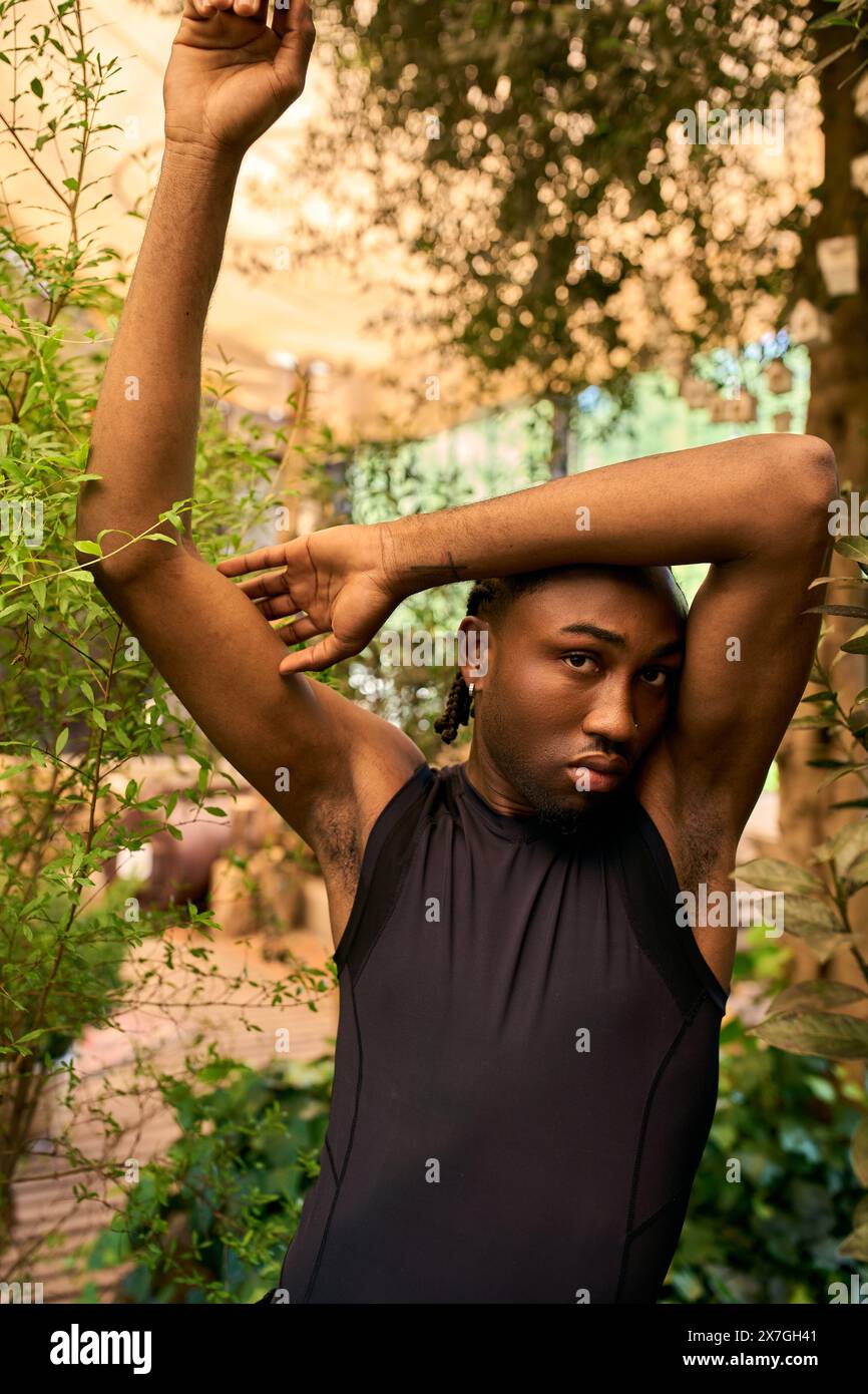Sophisticated African American man with dapper style raising his arms ...