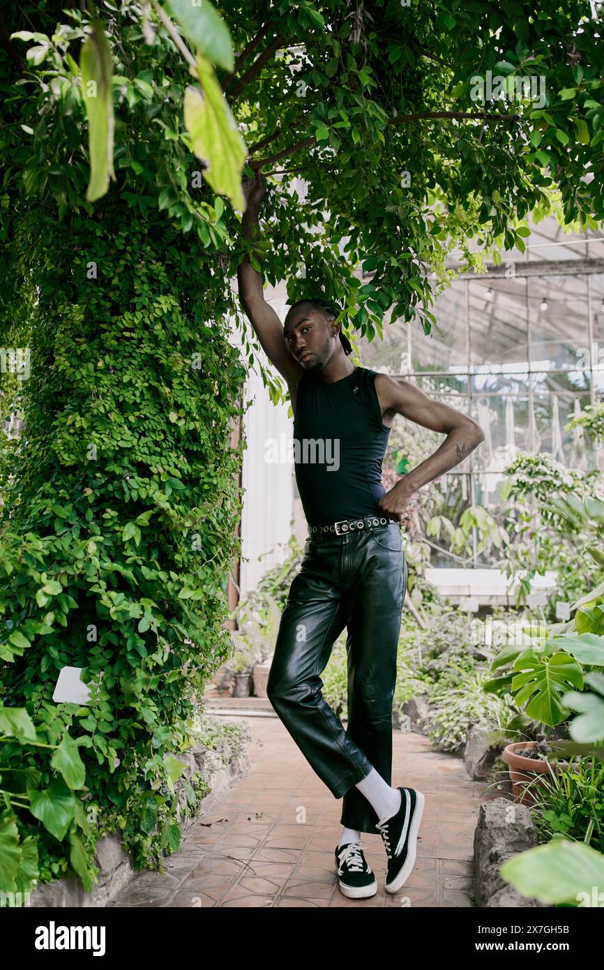 A sophisticated African American man in black attire standing ...