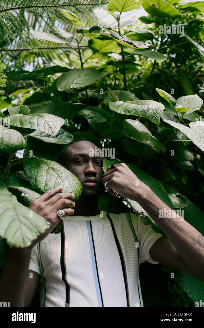 A handsome African American man in sophisticated dapper style poses in ...