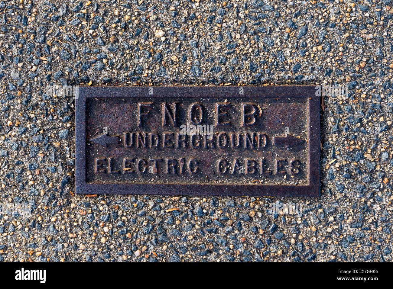 A steel sign or plaque embedded in a concrete footpath for the former ...