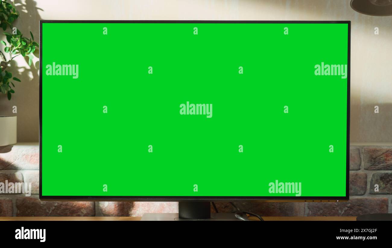 Desktop Personal Computer Monitor Standing on a Table with a Green ...