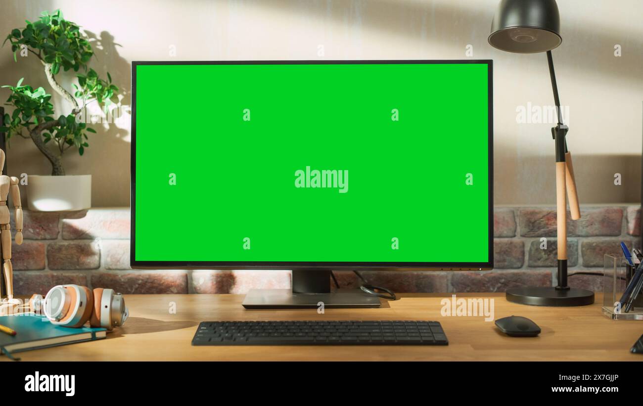 Desktop Personal Computer Monitor Standing on a Table with a Green ...