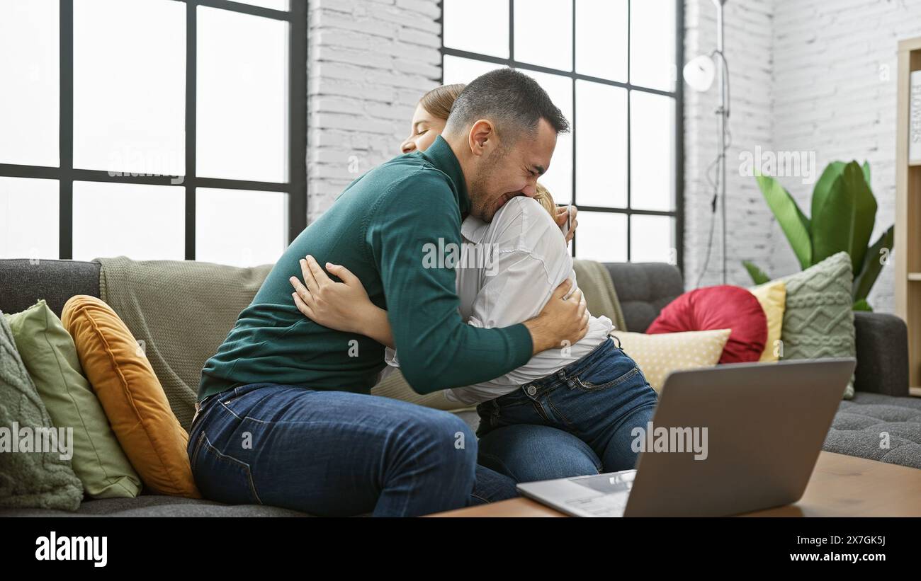 A man and woman embrace lovingly in a cozy, modern living room with a ...