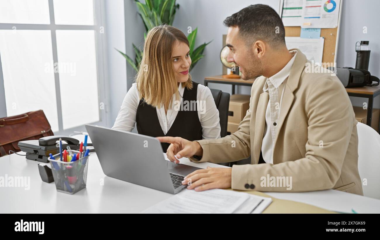 A woman and man in professional attire engage in a coworking session at ...