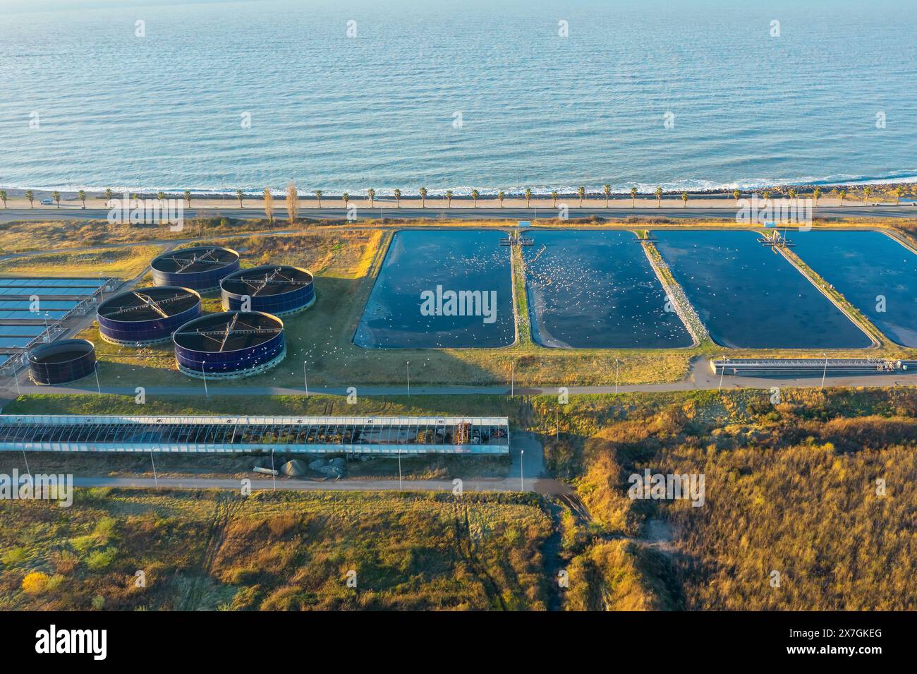 neAerial view of modern sewage treatment plant by the sea. Industrial ...