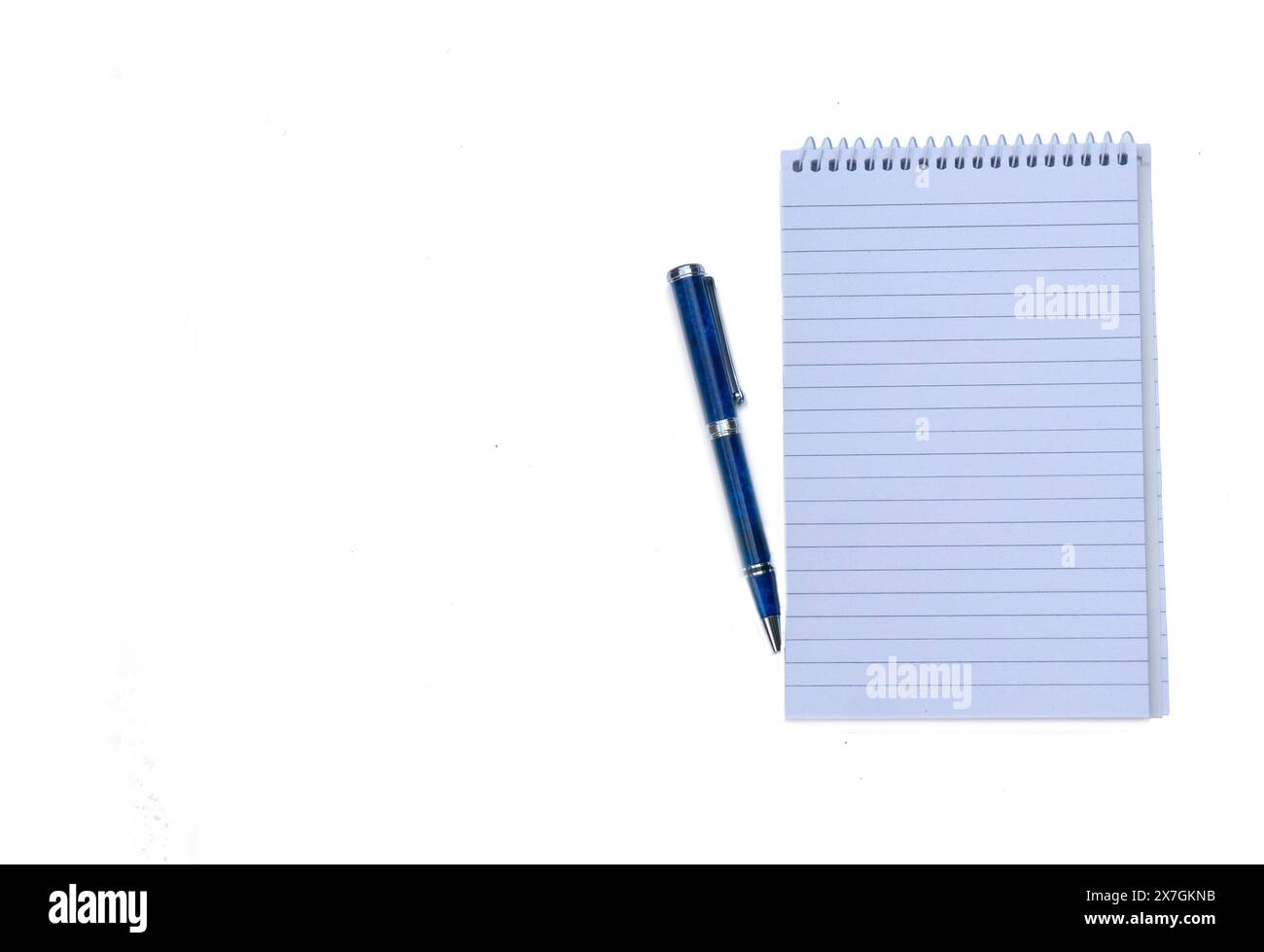 Top view of a open notebook with pen on a white background, school notebooks with a spiral ...