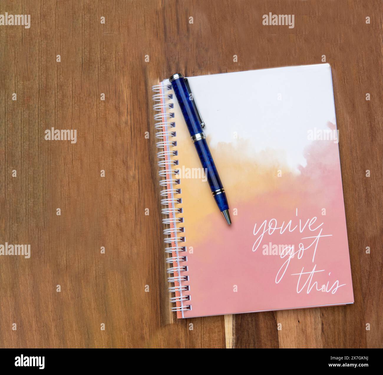 Blue Pen and Notepad on the wooden desk with motivational words Stock ...