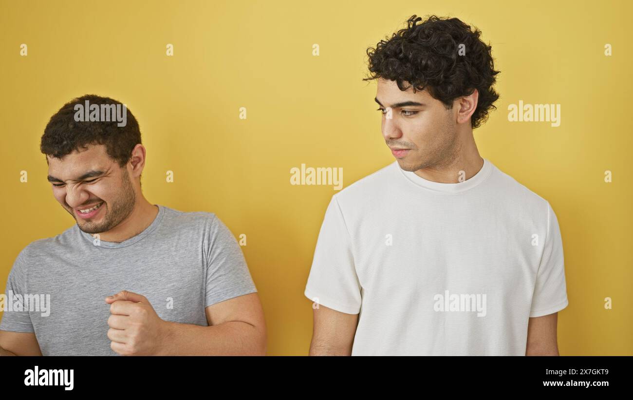 Two men expressing contrasting emotions over a yellow backdrop ...